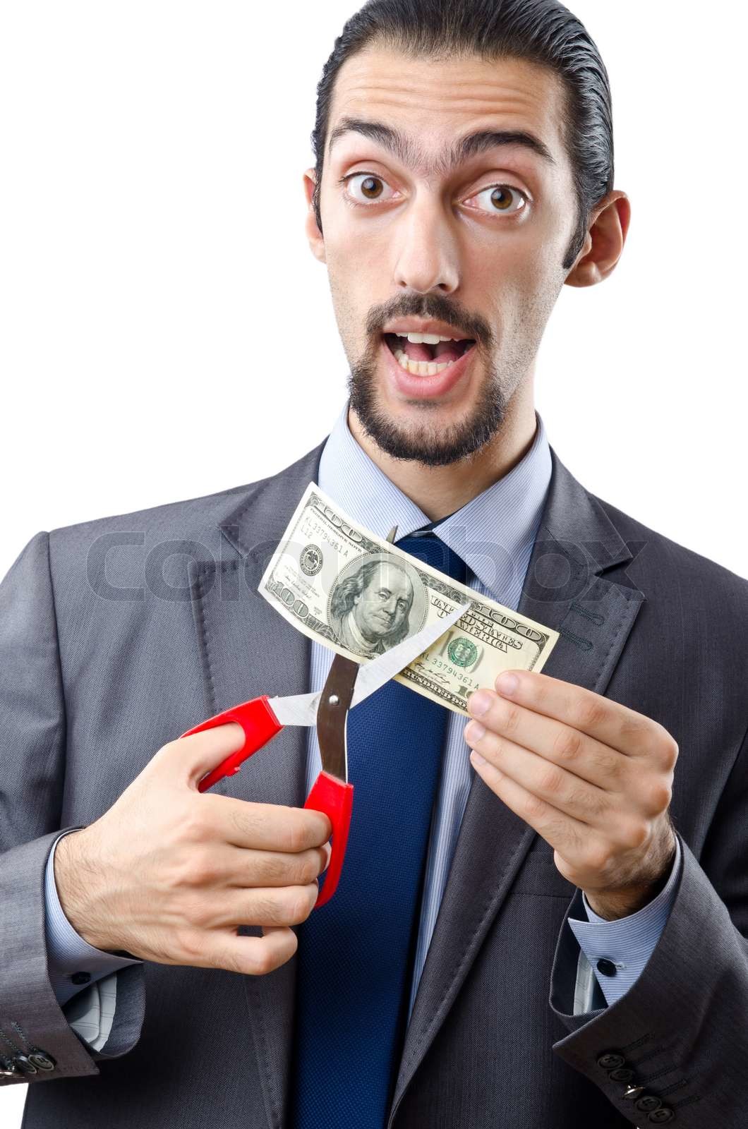 Man cutting money on white | Stock image | Colourbox