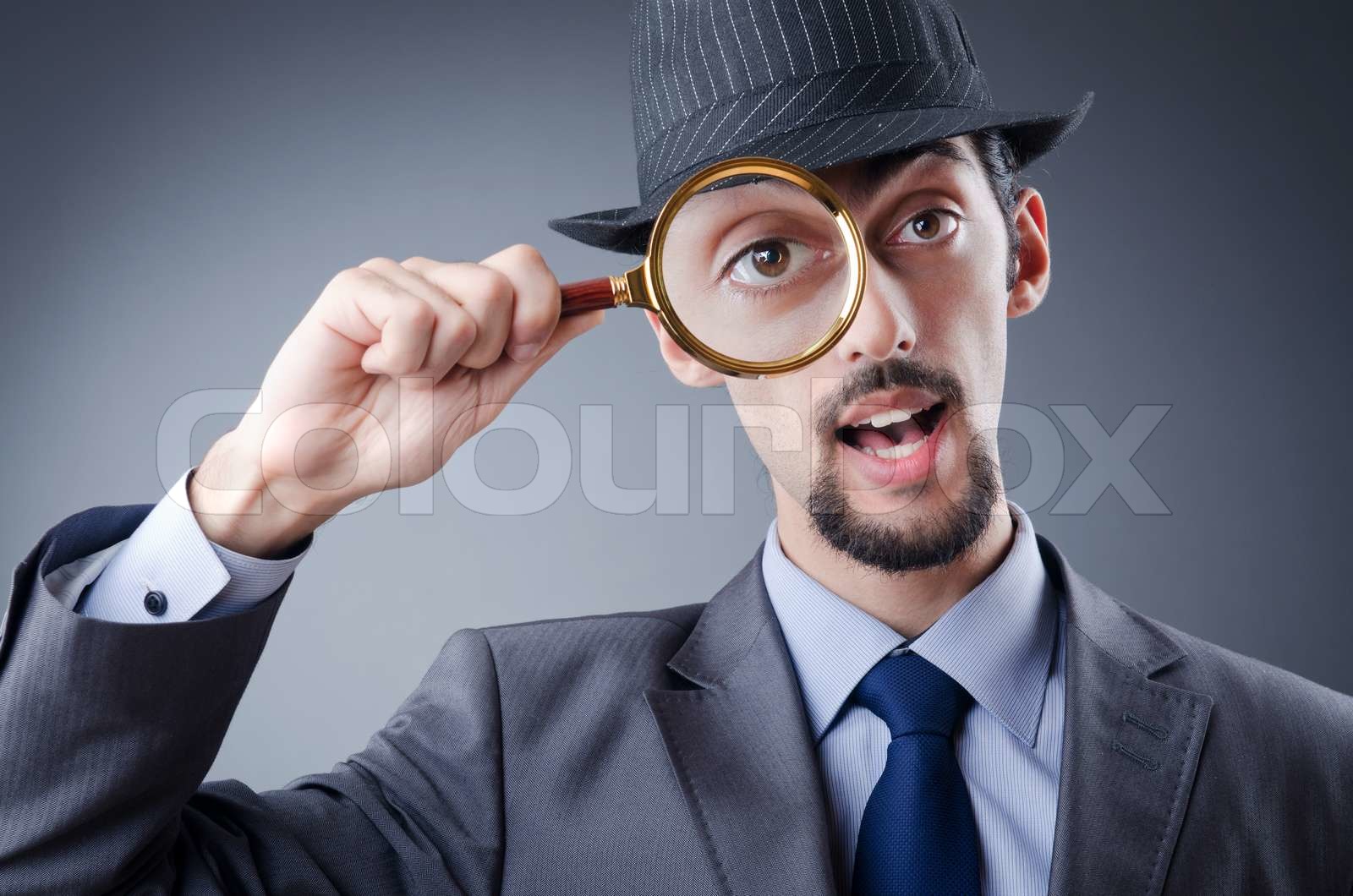 Detective and magnifying glass | Stock image | Colourbox