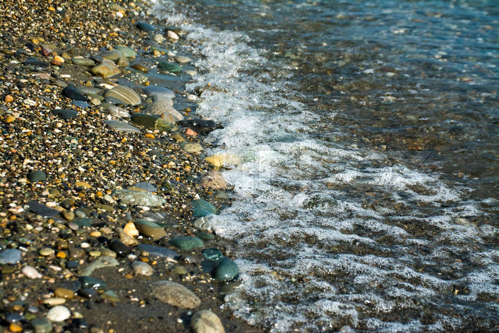 wave running on a pebble beach | Stock image | Colourbox