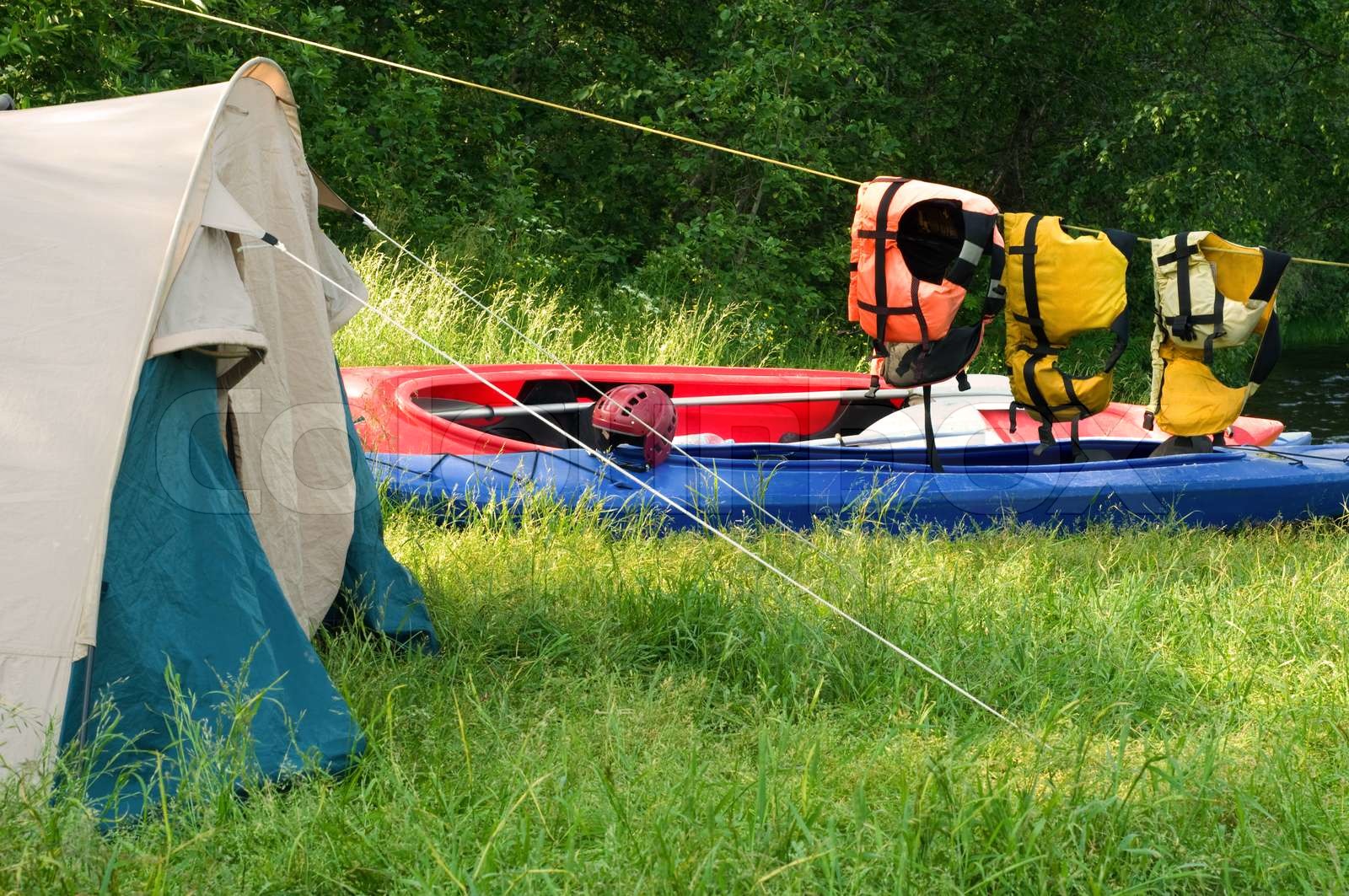 Tent set up for camping by a river | Stock image | Colourbox