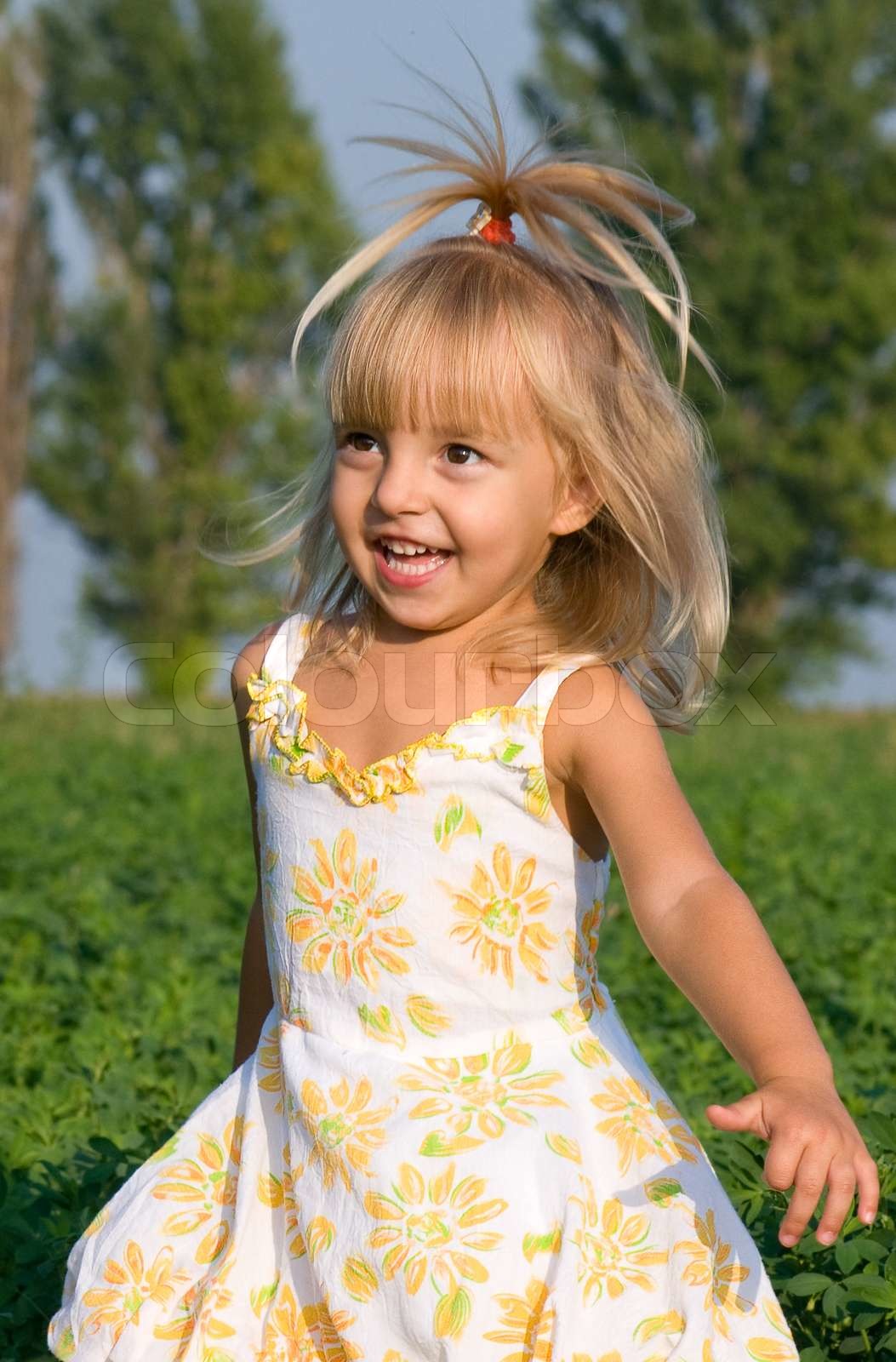 Portrait of the little girl in the field | Stock image | Colourbox