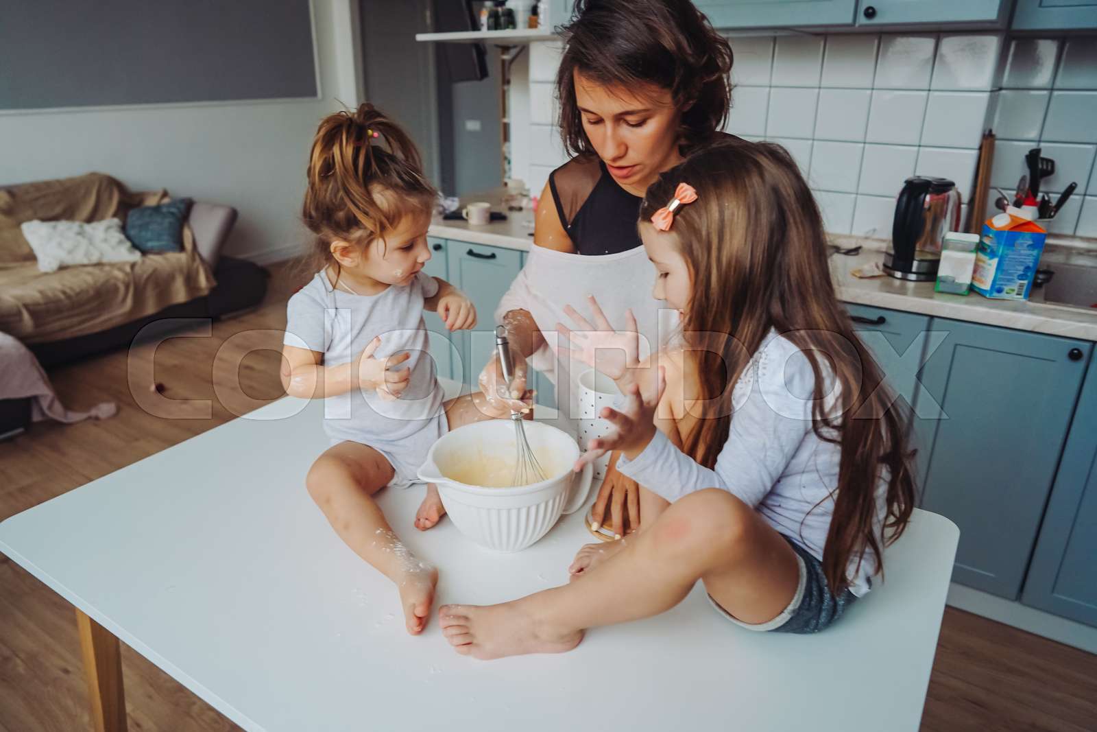 Happy family cook together in the kitchen | Stock image | Colourbox