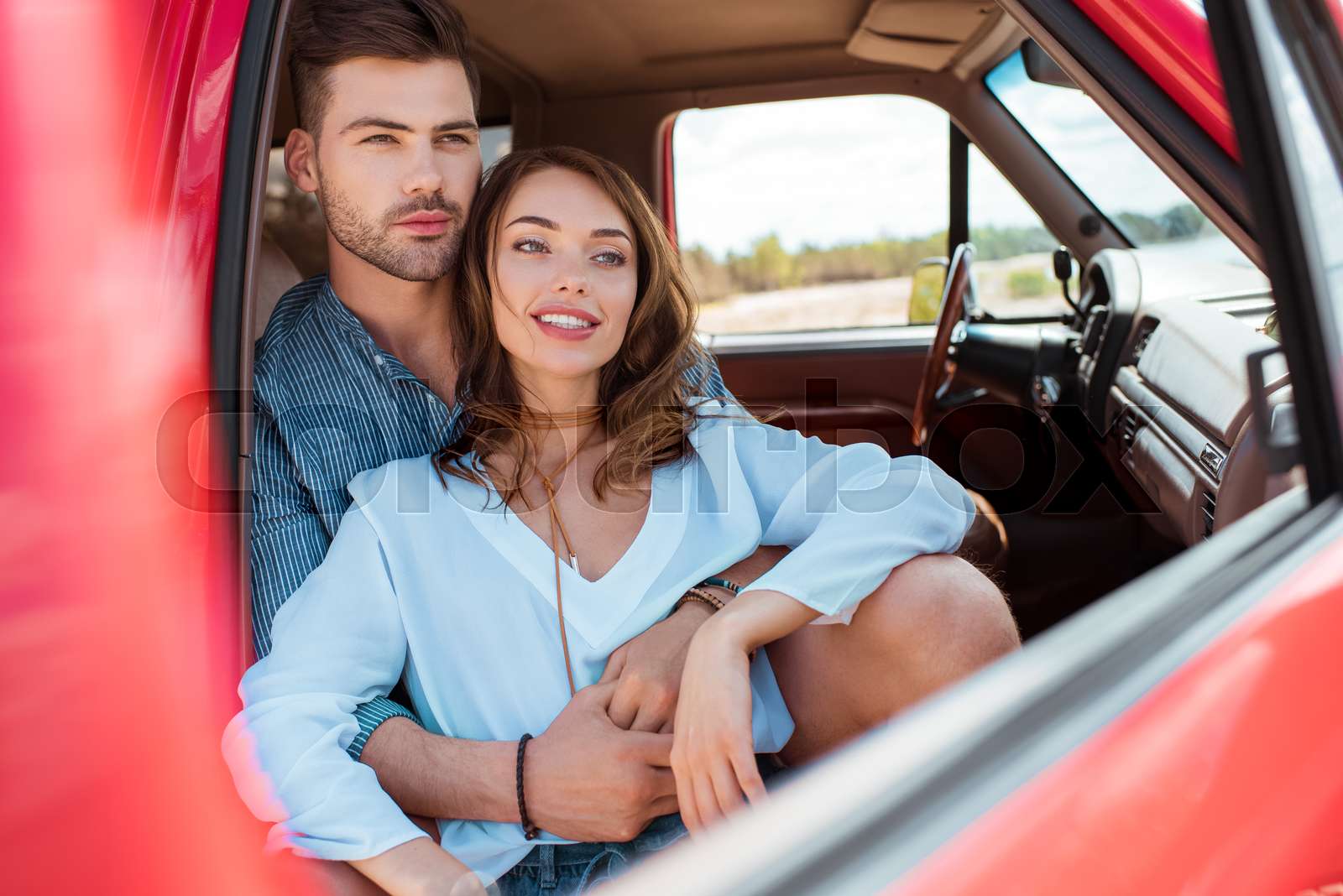 happy young couple of travelers hugging and sitting in car | Stock ...