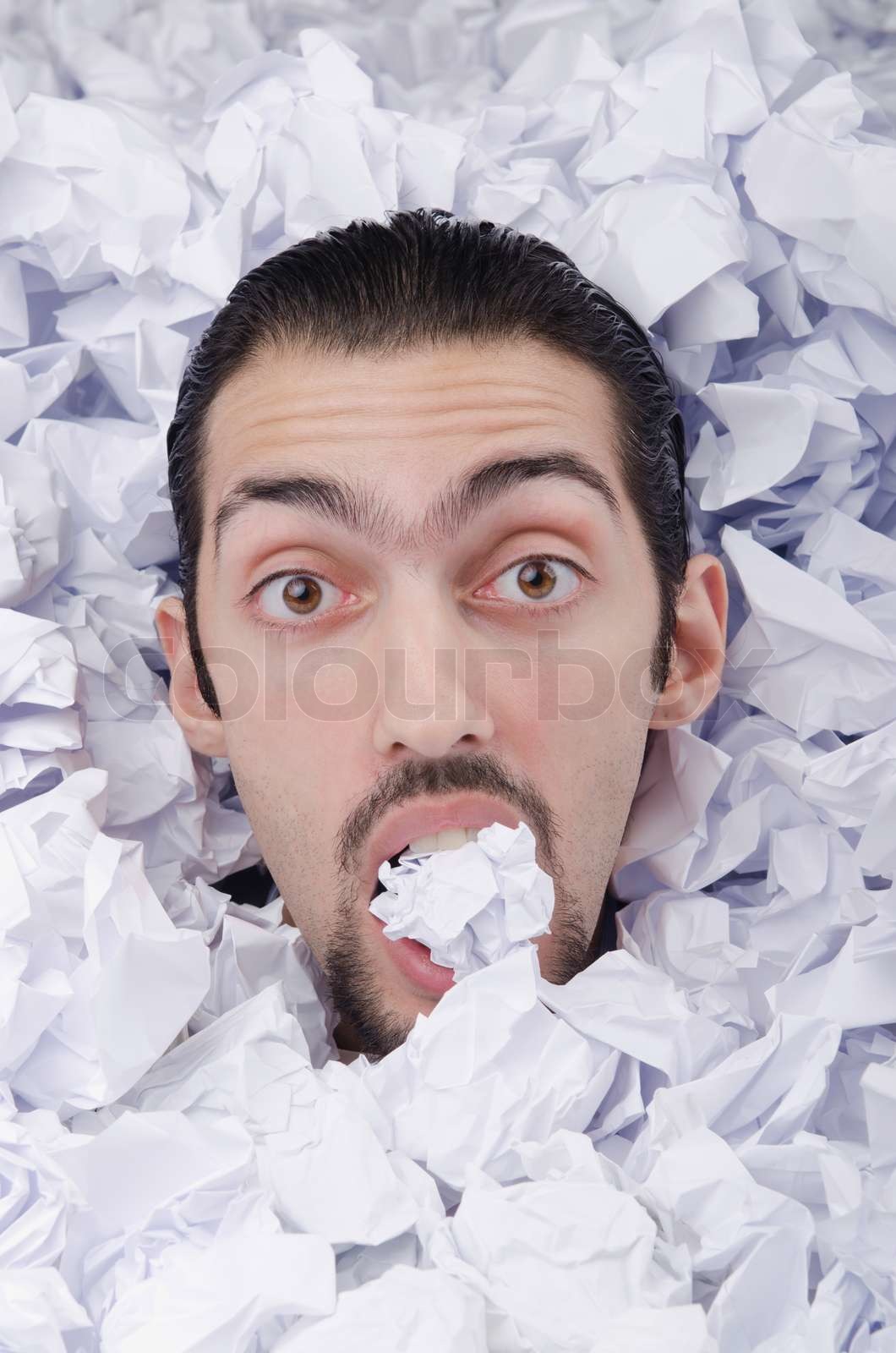 Man with lots of crumpled paper | Stock image | Colourbox