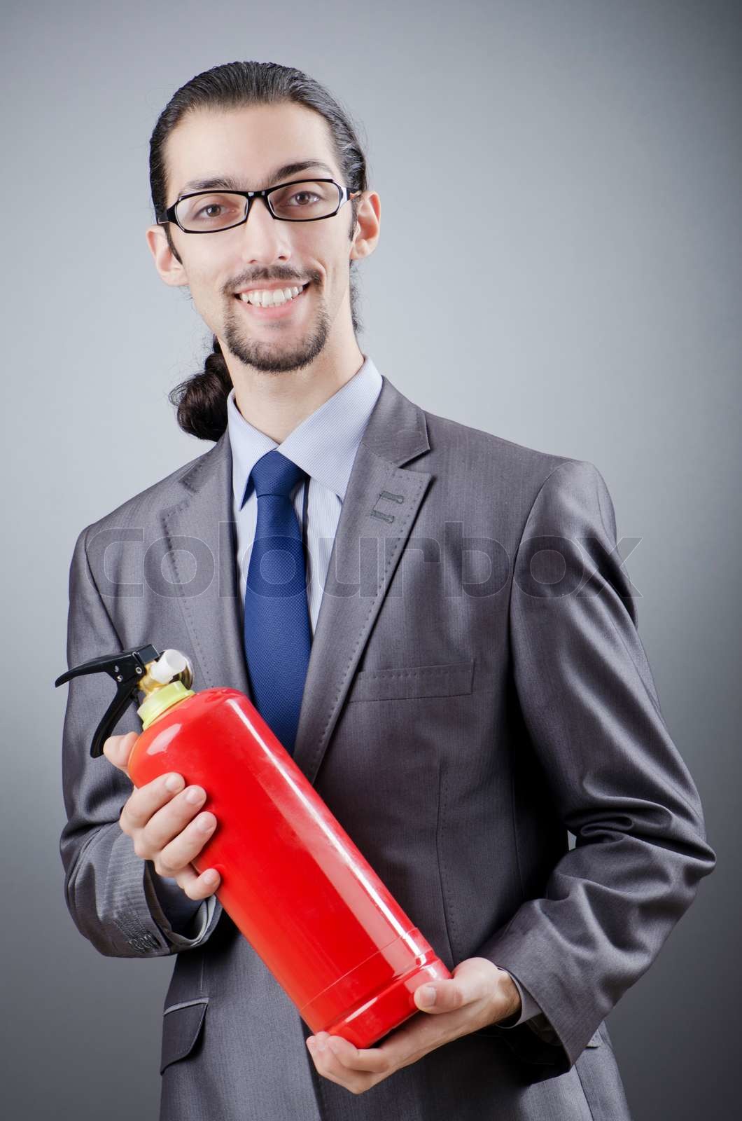 Man with fire extinguisher in firefighting concept | Stock image ...