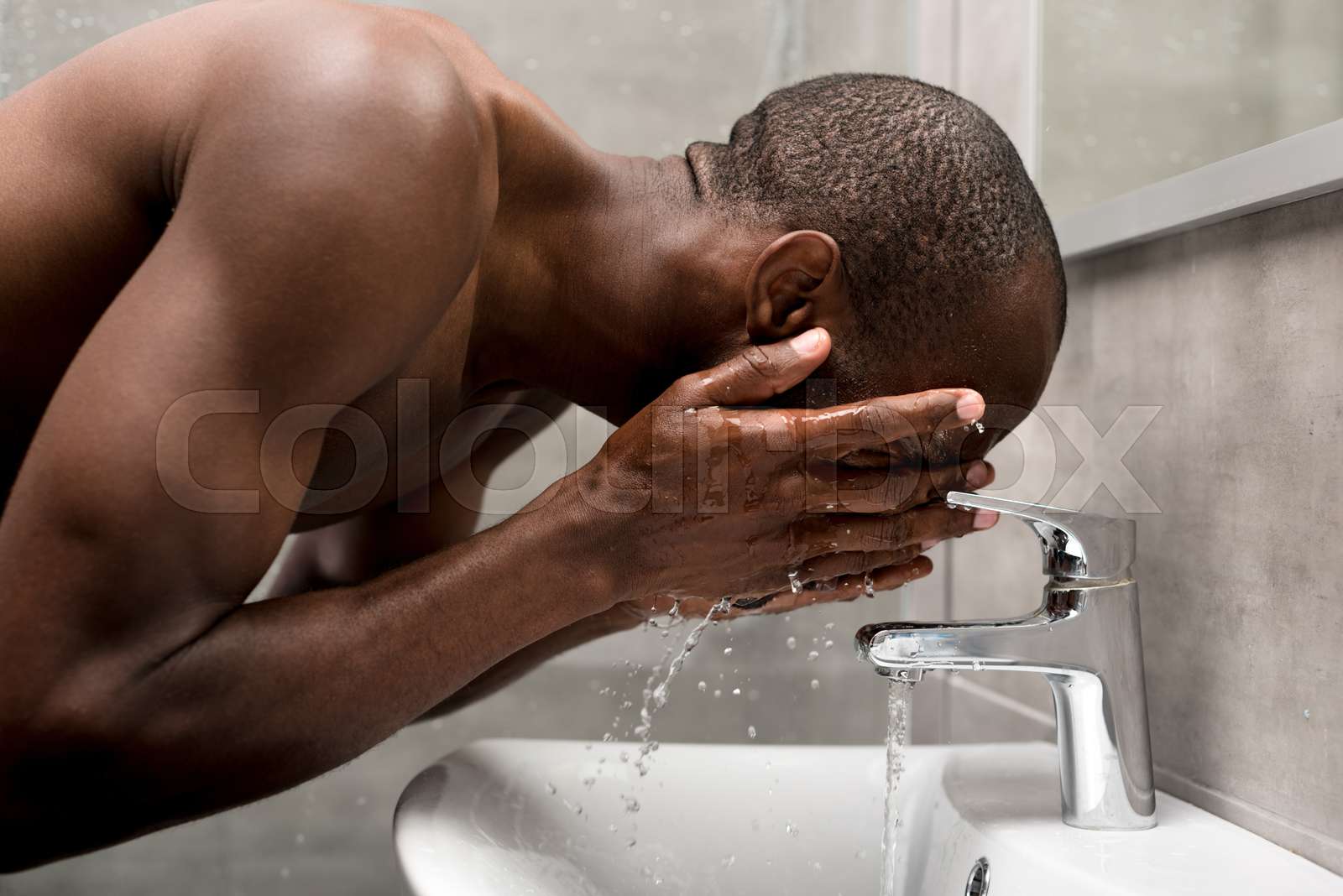 side view of handsome shirtless african american man washing in ...