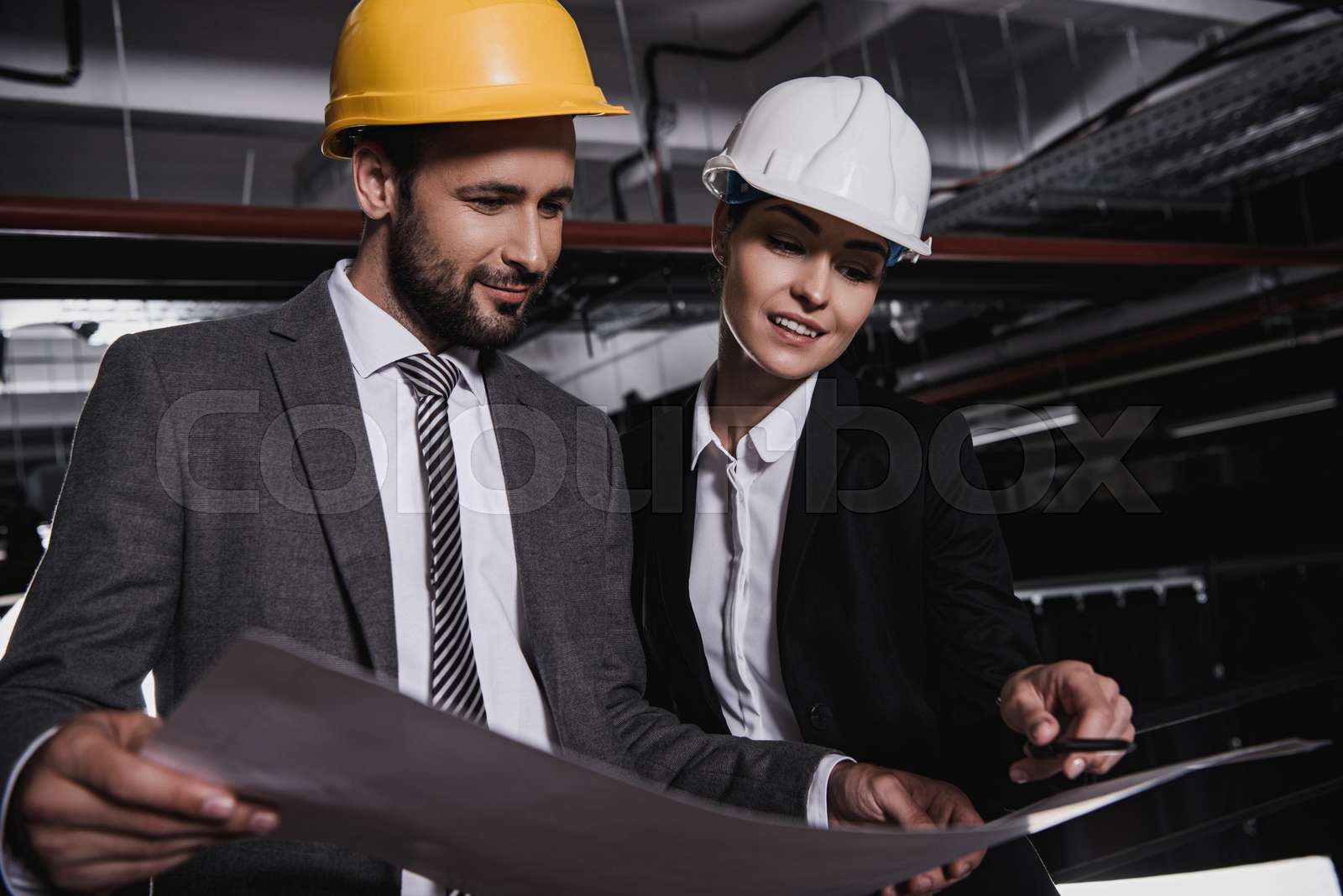 engineers in suits and hardhats working with blueprint | Stock image ...