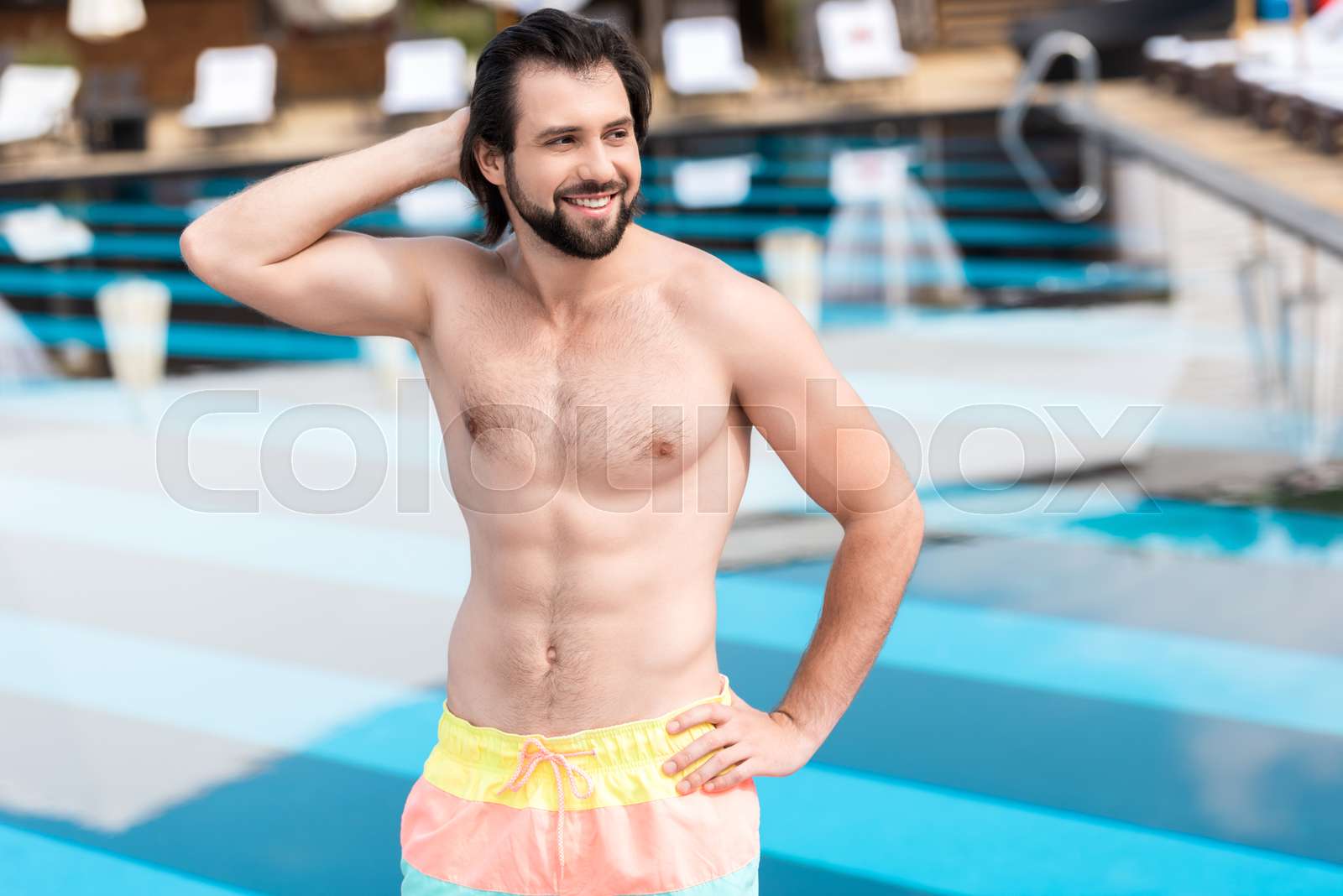 handsome bearded man posing near swimming pool | Stock image | Colourbox
