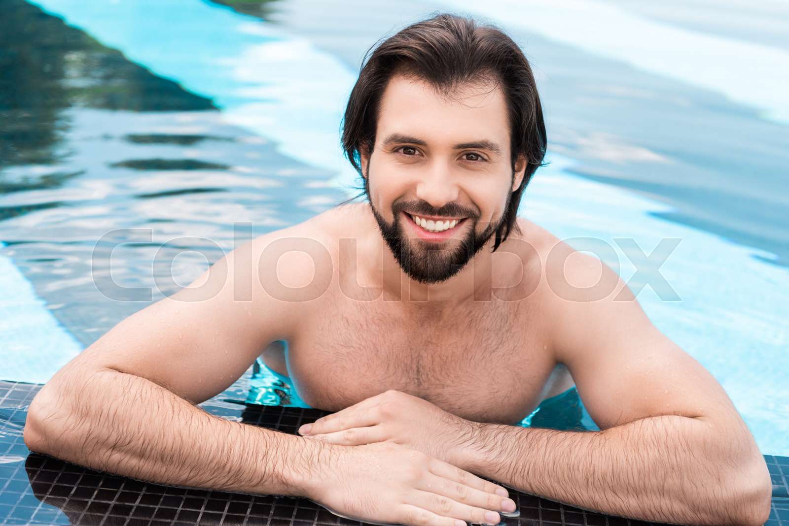 bearded smiling man in swimming pool looking at camera | Stock image ...