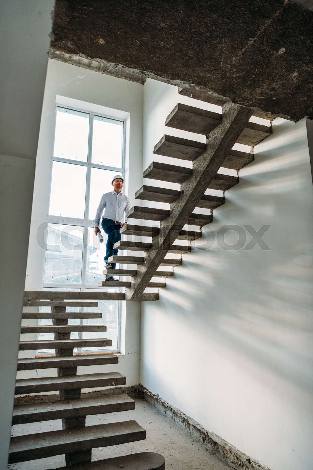 handsome architect going upstairs inside of building house | Stock ...