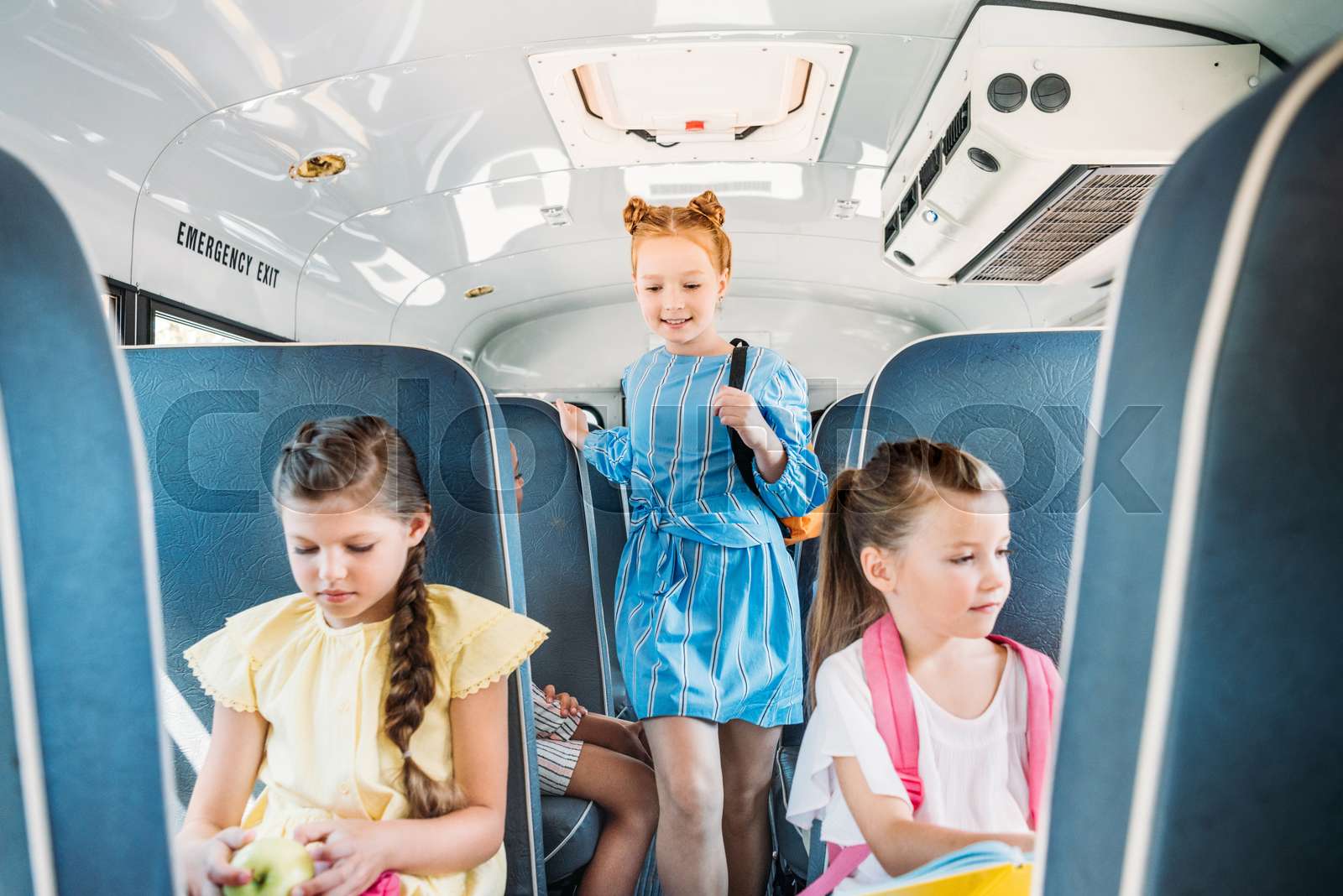 adorable little pupils riding on school bus during excursion | Stock ...
