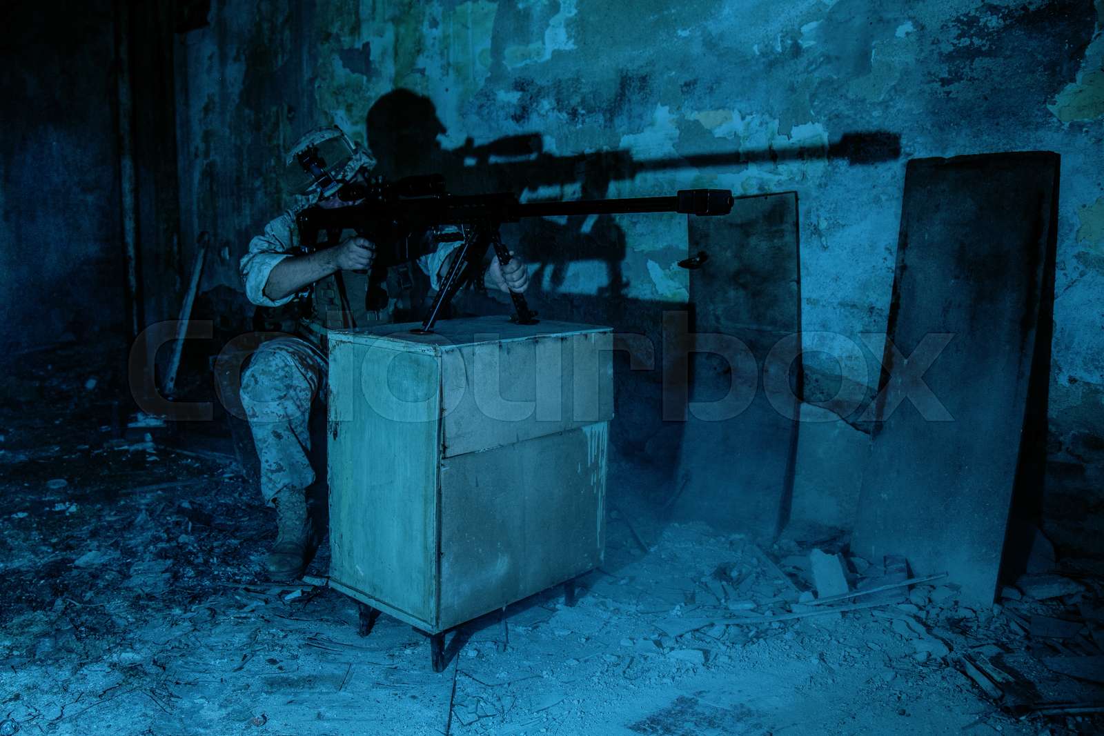 Army sniper firing with 50 caliber rifle at night | Stock image | Colourbox