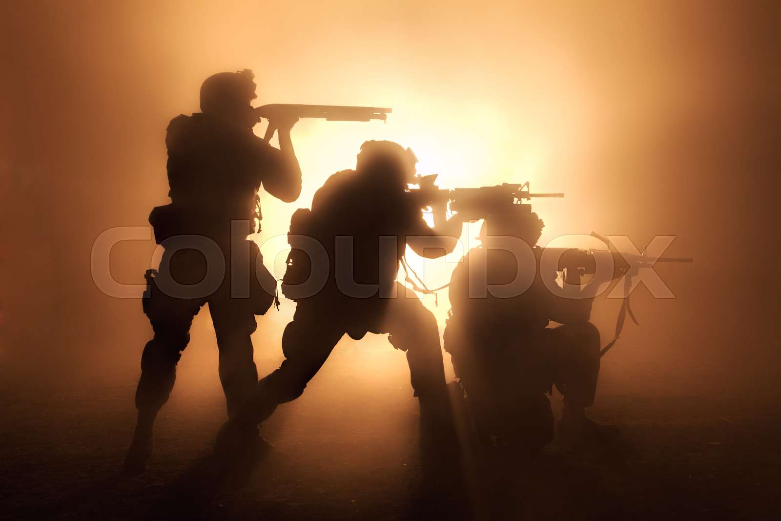 Two attacking soldiers surrounded flame and smoke | Stock image | Colourbox