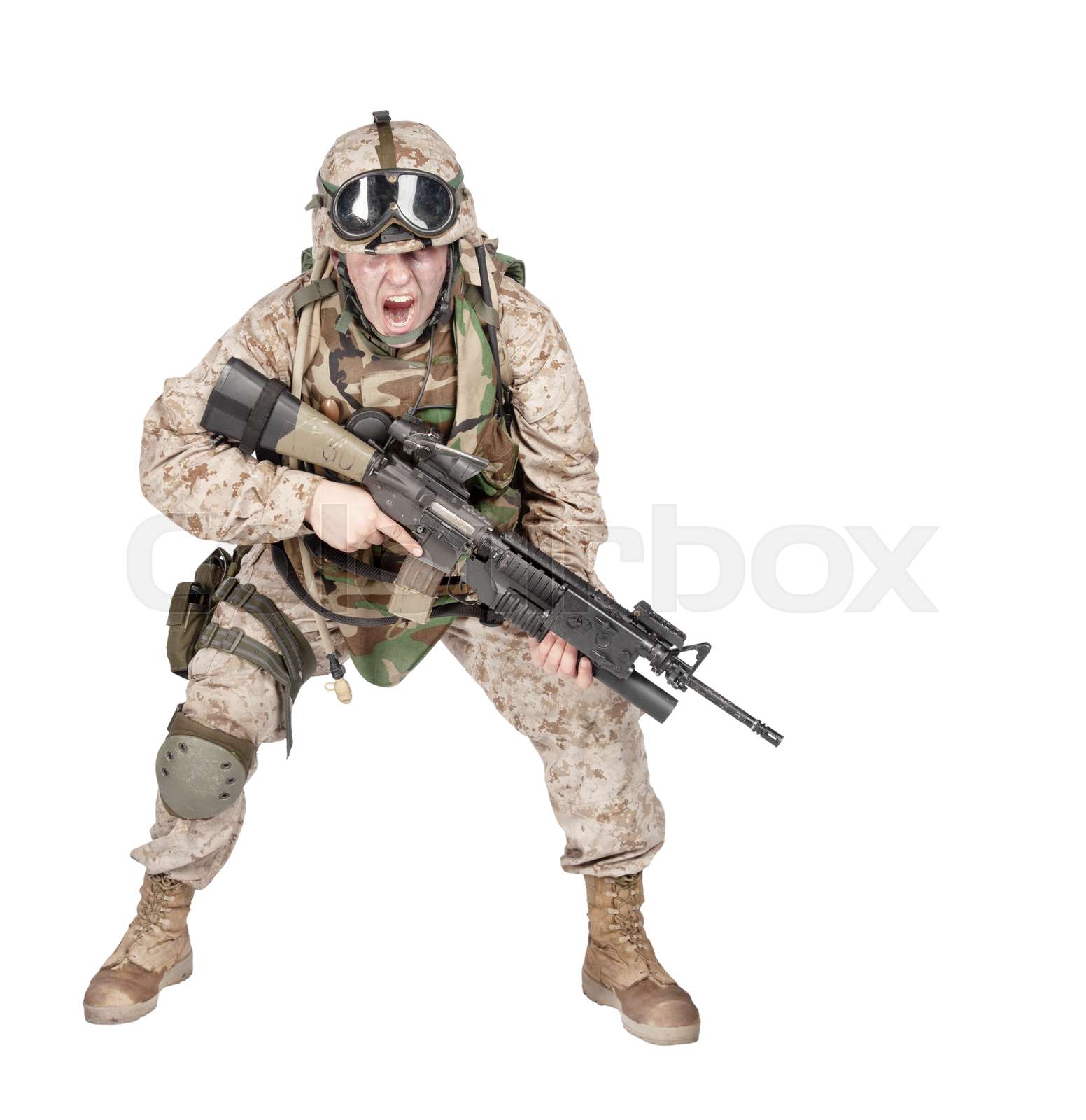 Soldier crouching under fire and screaming orders | Stock image | Colourbox