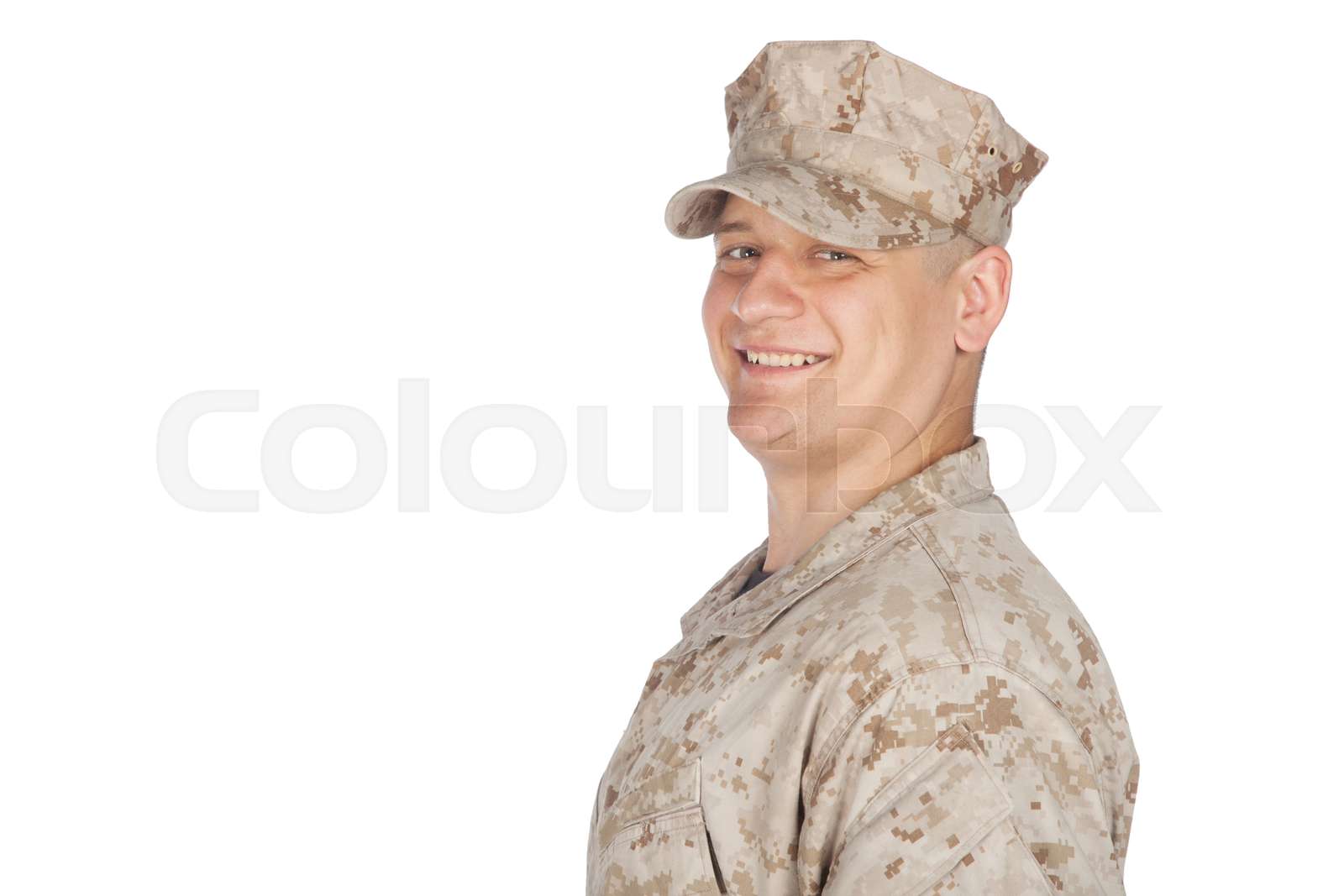 Saluting and smiling army soldier studio shoot | Stock image | Colourbox