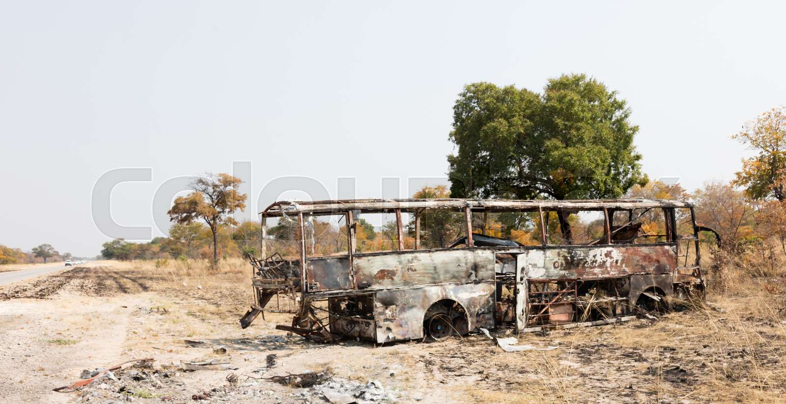Burned bus at the side of the road | Stock image | Colourbox