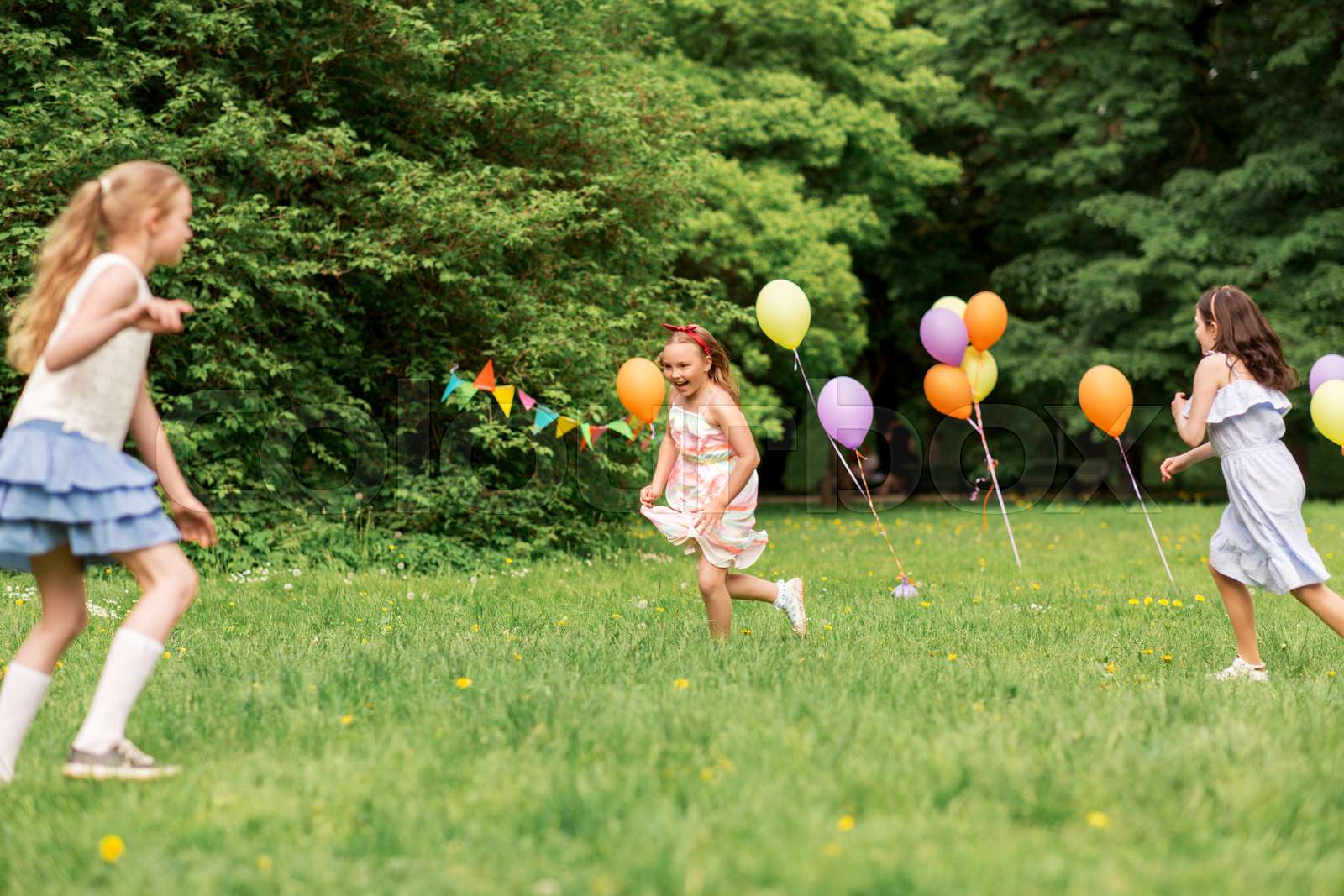 happy girls playing tag game at birthday party | Stock image | Colourbox