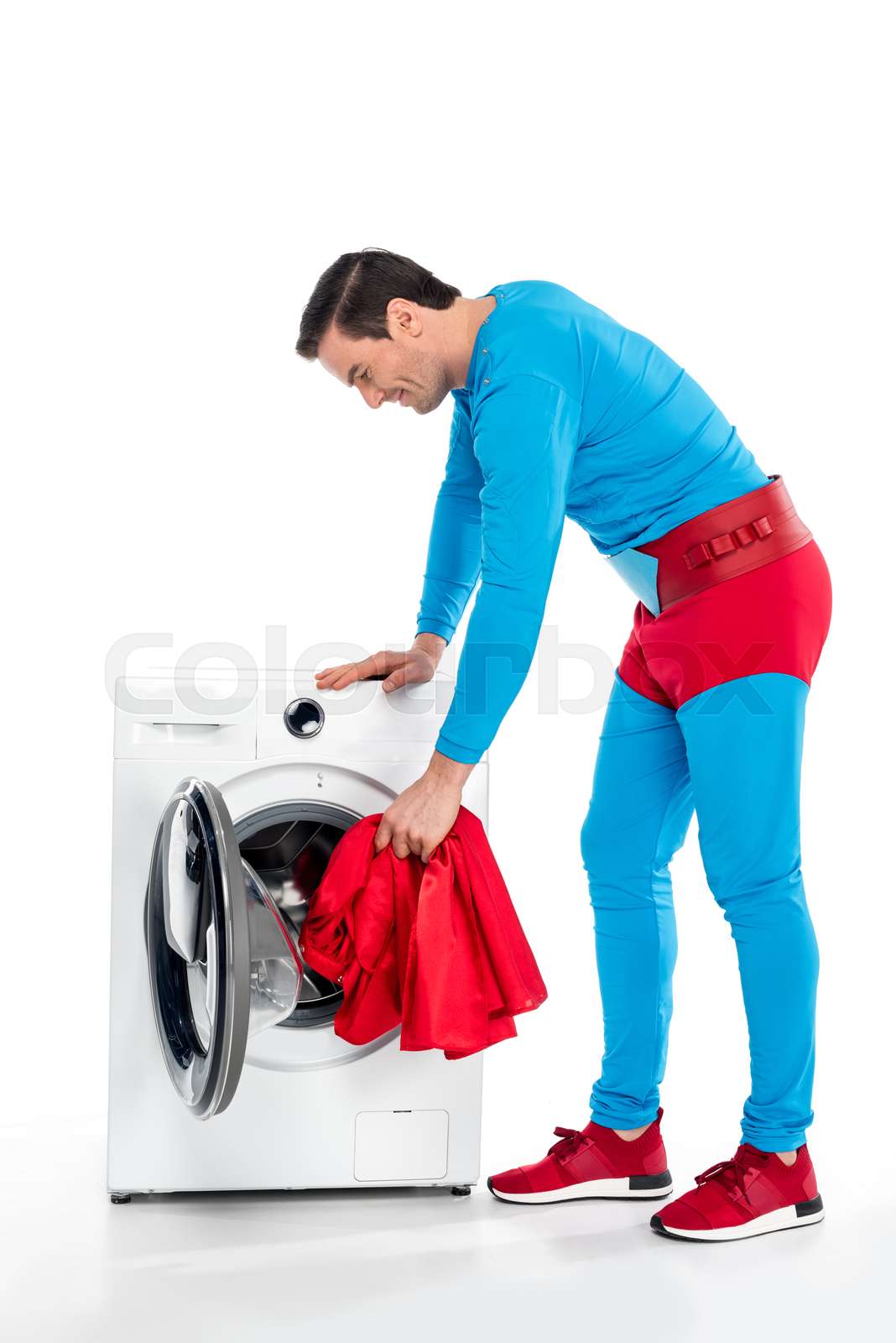 smiling washing clothes in washing machine on white | Stock image ...
