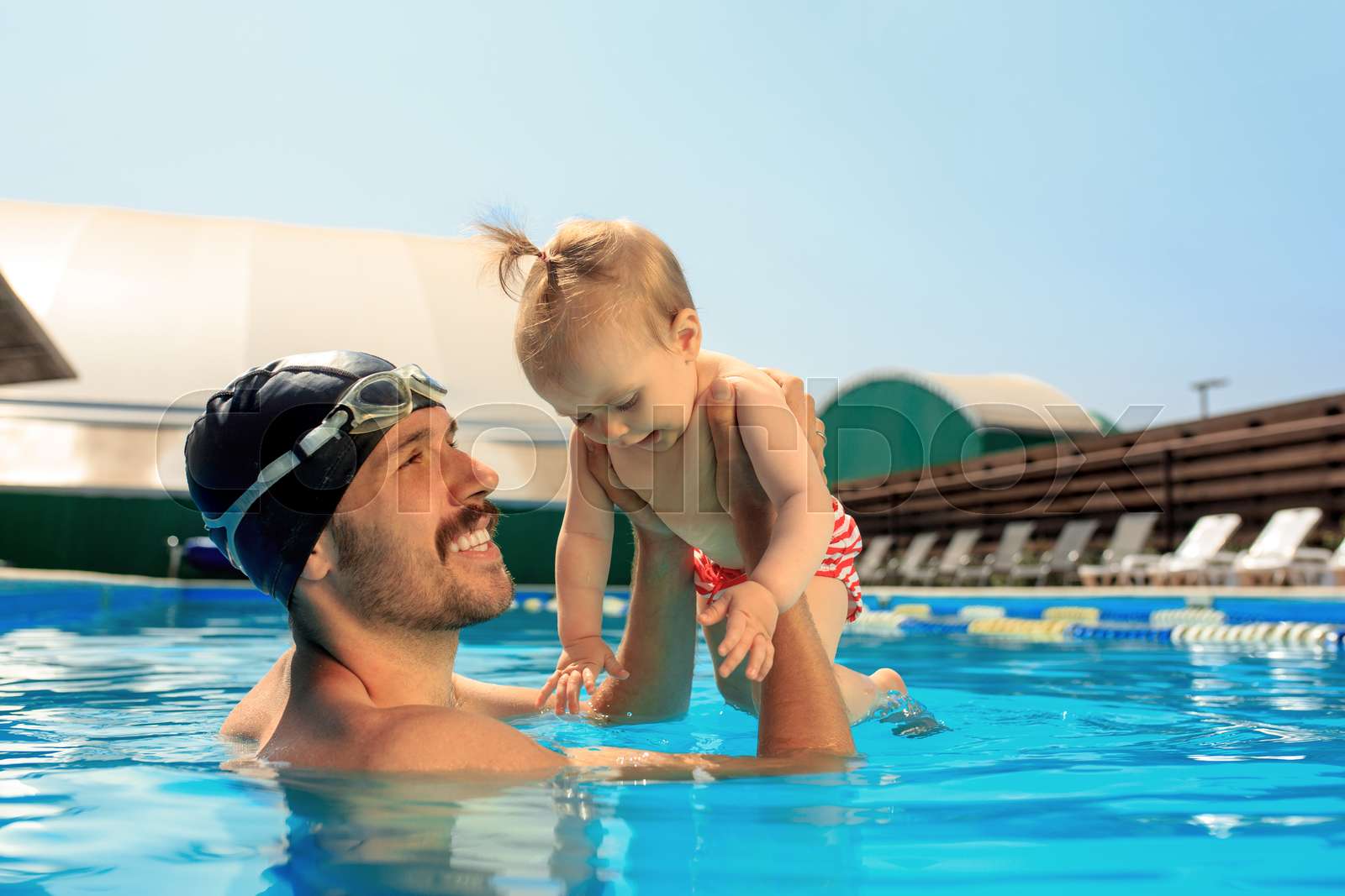 Happy family having fun by the swimming pool | Stock image | Colourbox