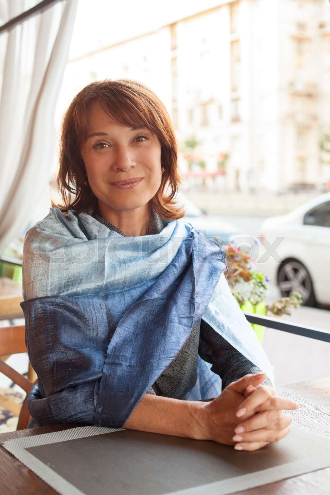 Beautiful older woman sitting in street cafe | Stock image | Colourbox