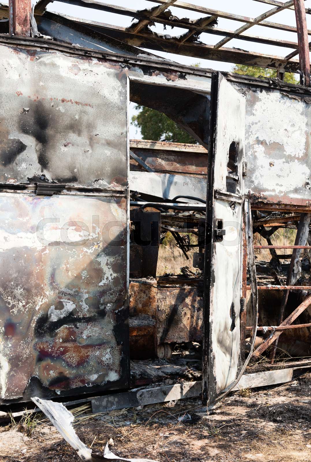 Burned bus at the side of the road, door | Stock image | Colourbox