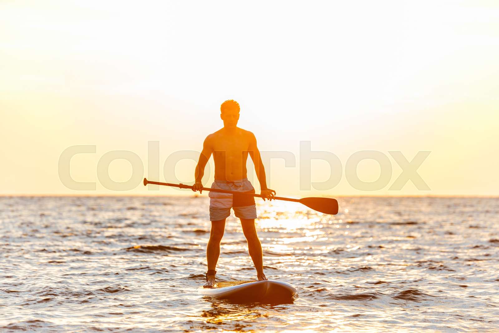 Handsome man kayaking on lake sea. | Stock image | Colourbox
