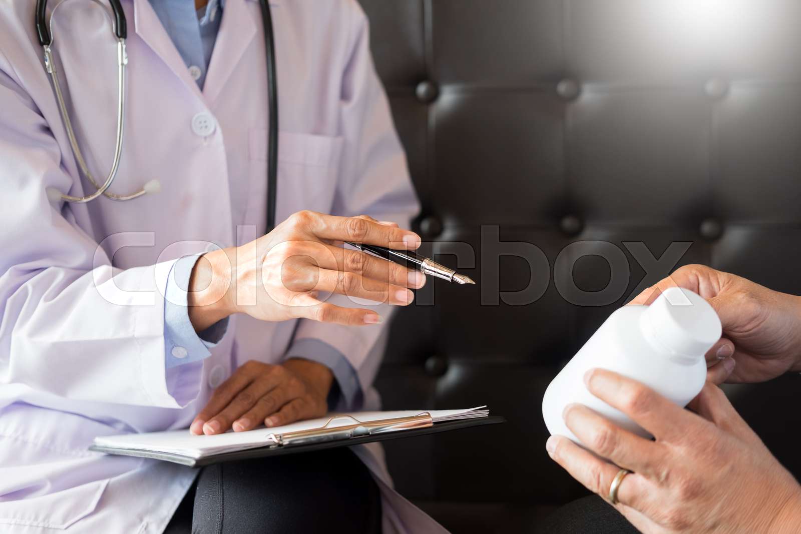 doctor hand holding tablet of drug and explain to patient in hospital ...