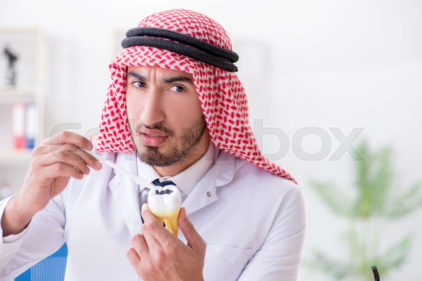Arab dentist working on new teeth implant | Stock image | Colourbox