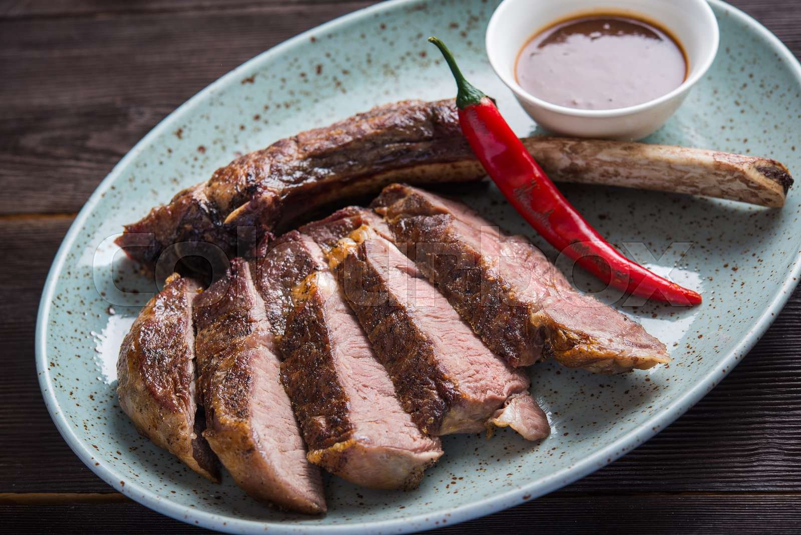 tomahawk rib steak with bbq sauce | Stock image | Colourbox