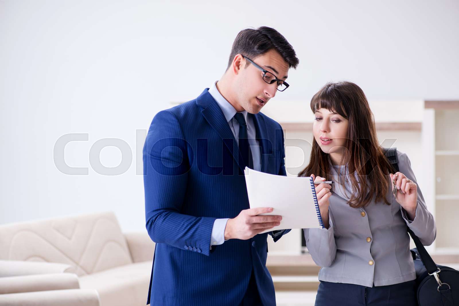 Real estate agent showing new apartment to owner | Stock image | Colourbox