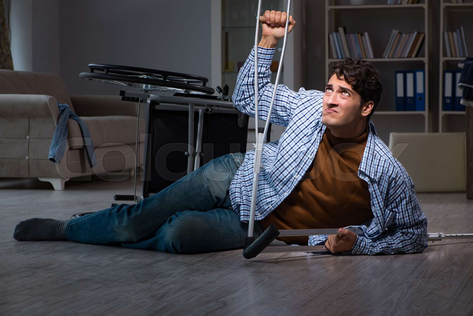 Man fell off wheelchair sitting on the floor | Stock image | Colourbox