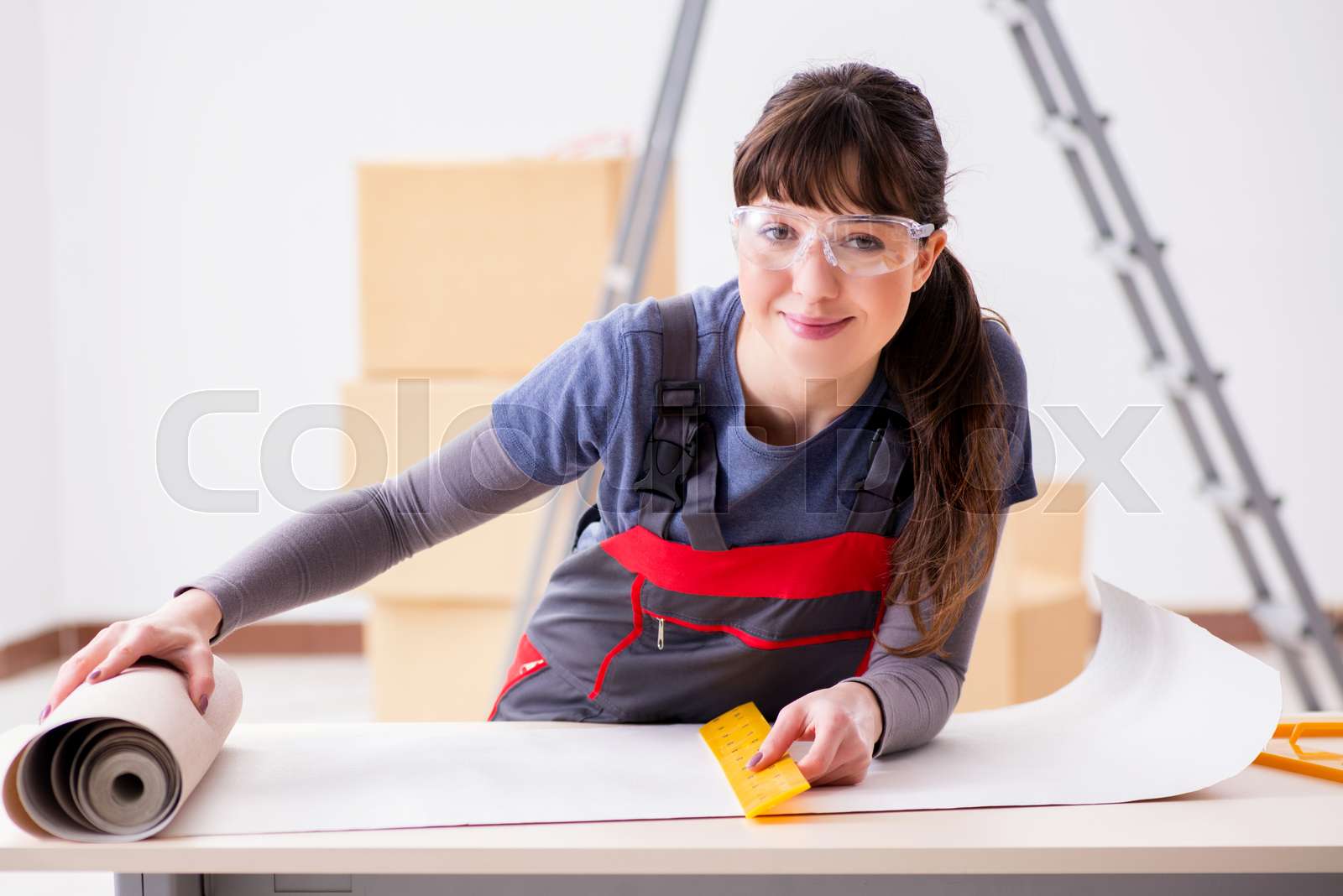 Woman preparing for wallpaper work | Stock image | Colourbox