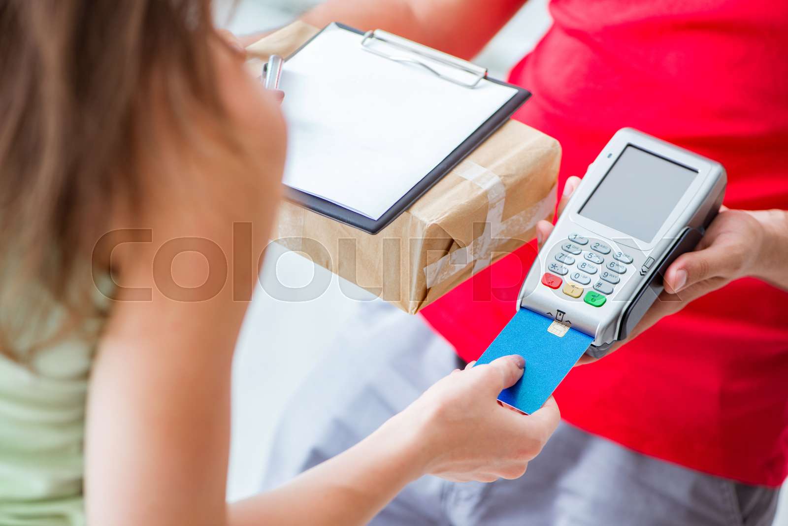 Parcel delivery being paid with pos and credit card | Stock image ...