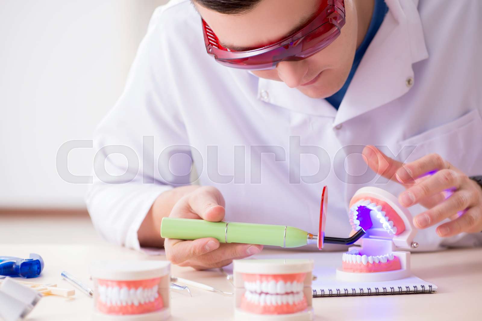 Dentist working teeth implant in medical lab | Stock image | Colourbox