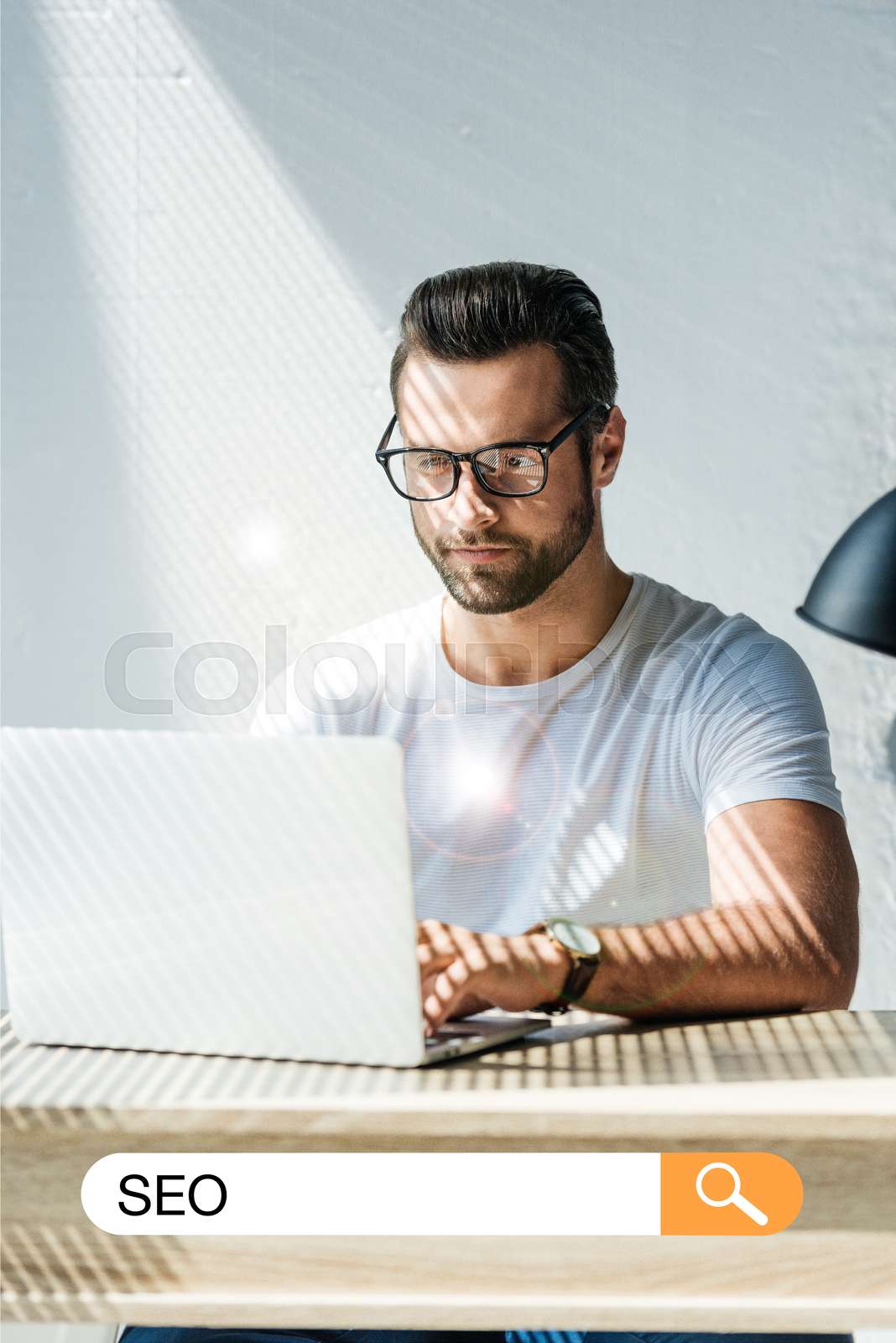 handsome developer working with laptop with SEO search bar | Stock ...