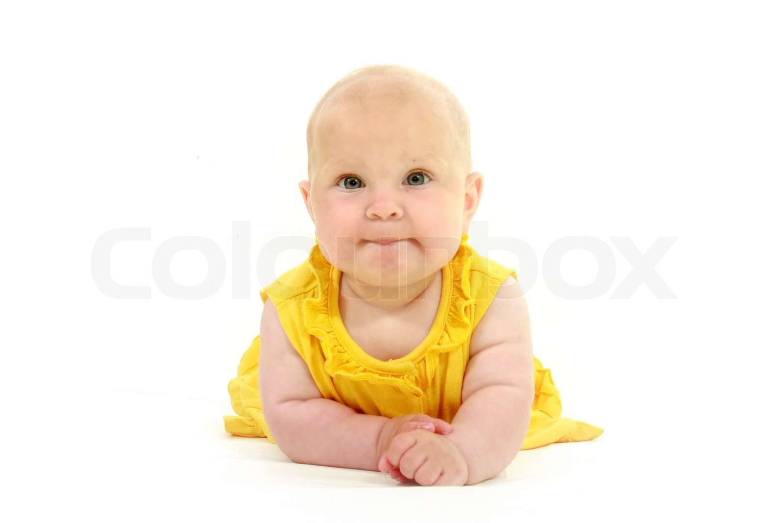cute baby in yellow over white | Stock image | Colourbox