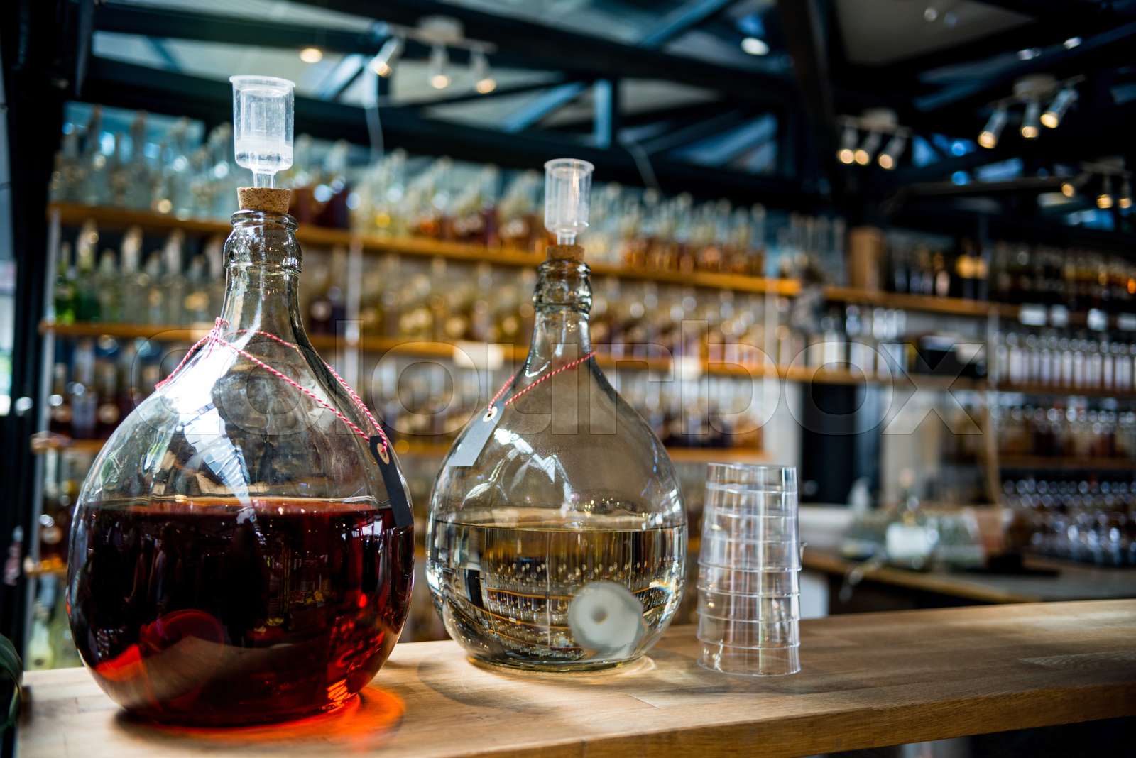 Selective focus of jugs with different alcohol drinks on bar counter ...
