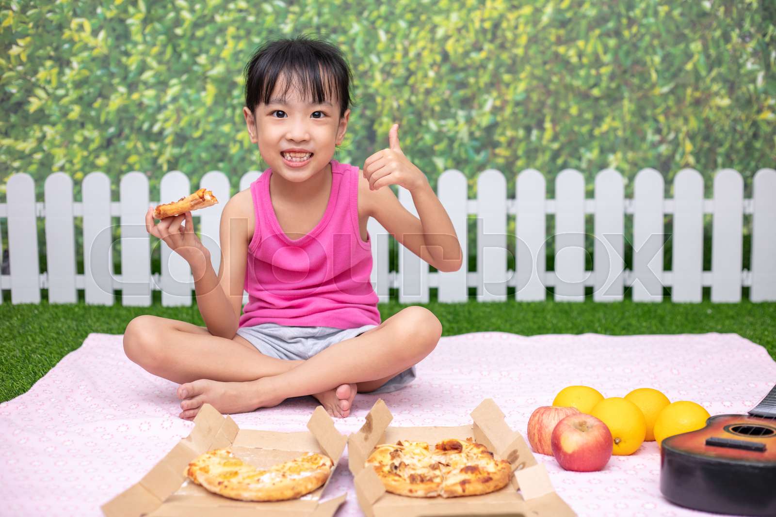 Asian Chinese litter girl Eating Pizza | Stock image | Colourbox