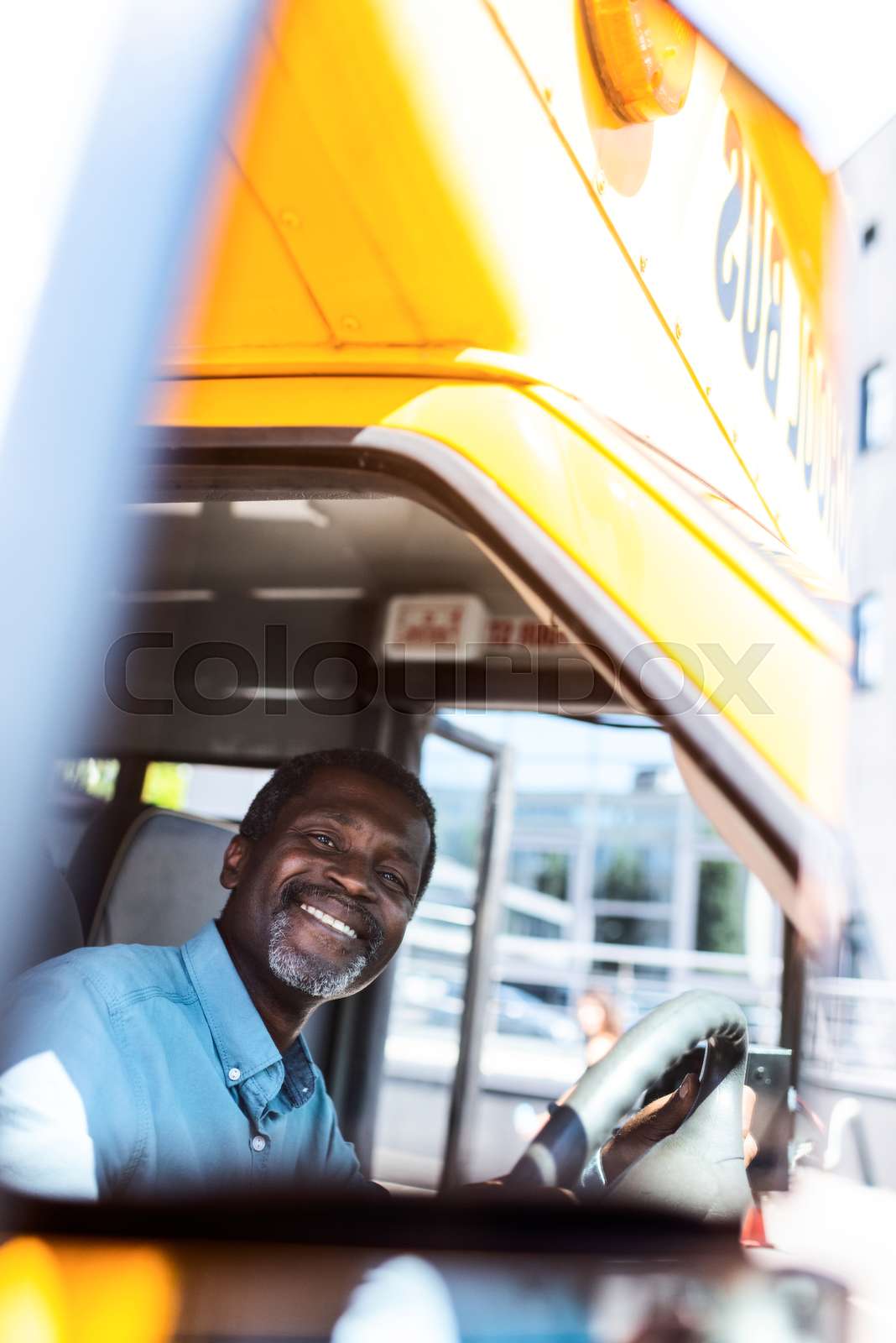 happy mature african american bus driver looking at camera | Stock ...