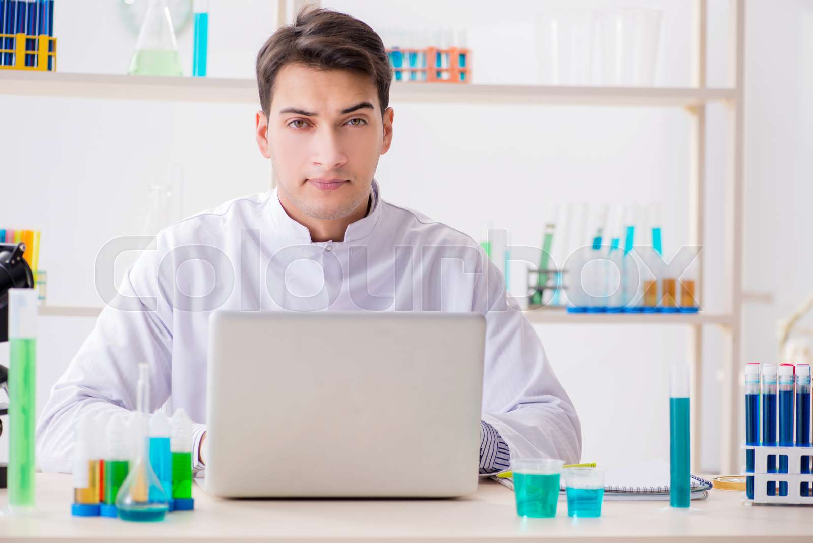Man student working in chemical lab on experiment | Stock image | Colourbox