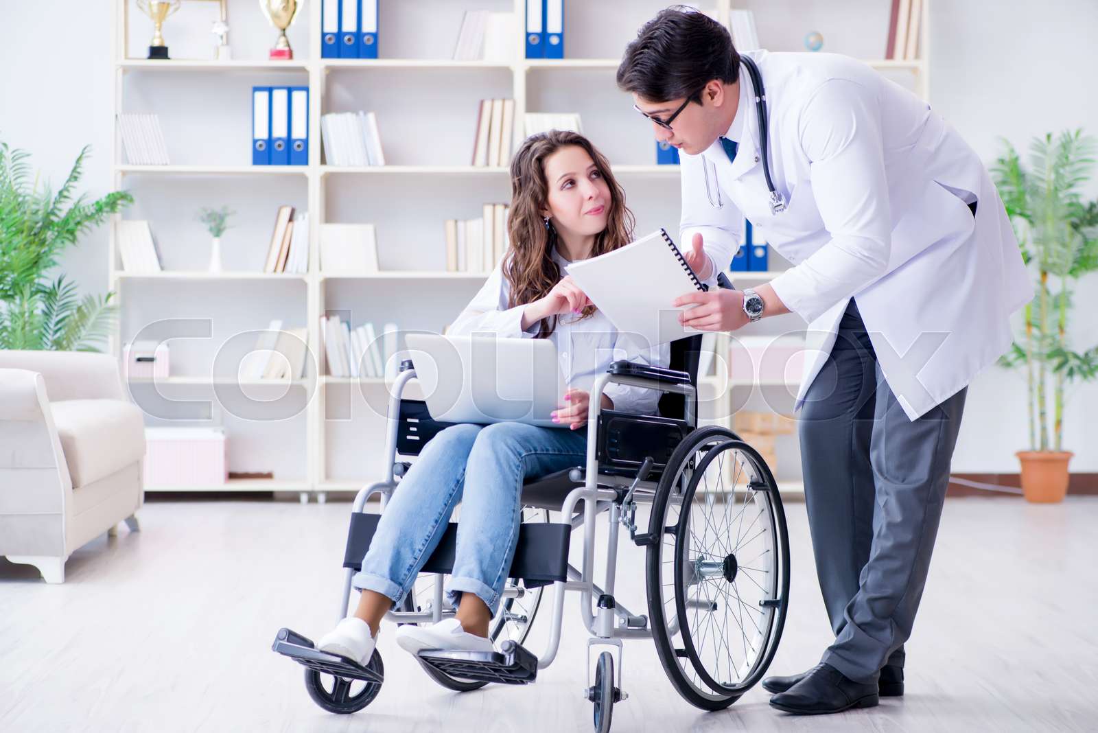 Disabled patient on wheelchair visiting doctor for regular check ...