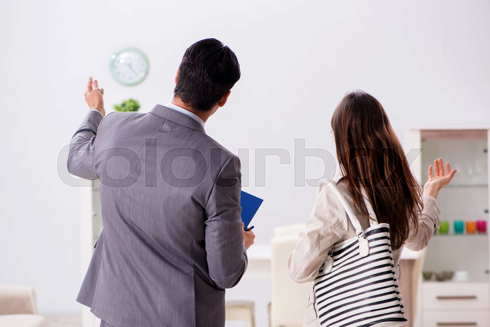 Real estate agent showing new apartment property to client | Stock ...