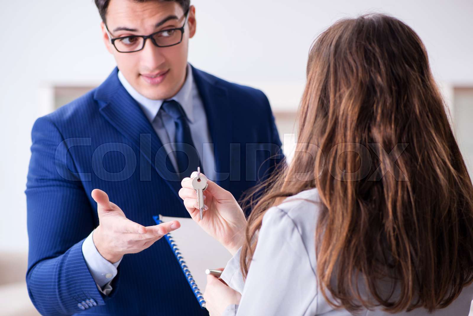 Real estate agent showing new apartment to owner | Stock image | Colourbox