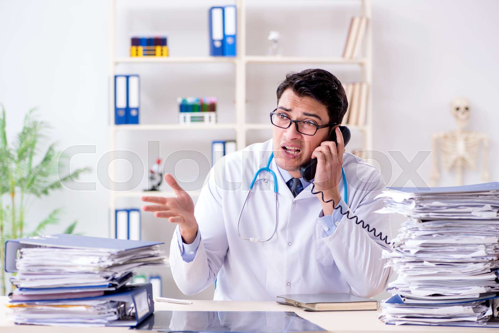 Busy doctor with too much work in hospital | Stock image | Colourbox