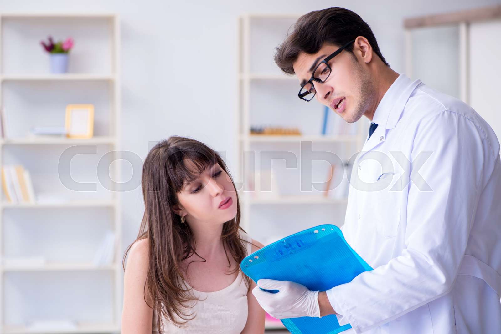 Doctor examining the skin of female patient | Stock image | Colourbox