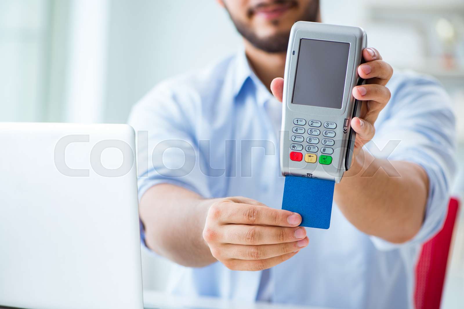 Man processing credit card transaction with POS terminal | Stock image ...