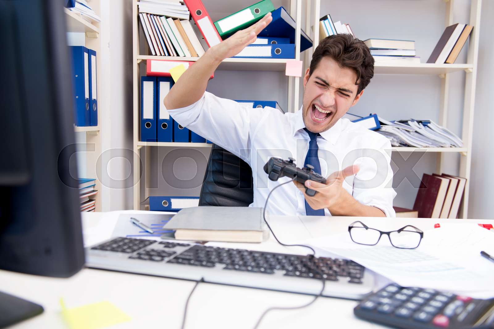 Employee playing computer games in the office | Stock image | Colourbox