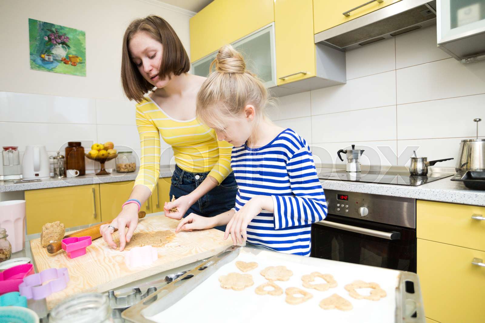 Sister girls cook n the kitchen | Stock image | Colourbox