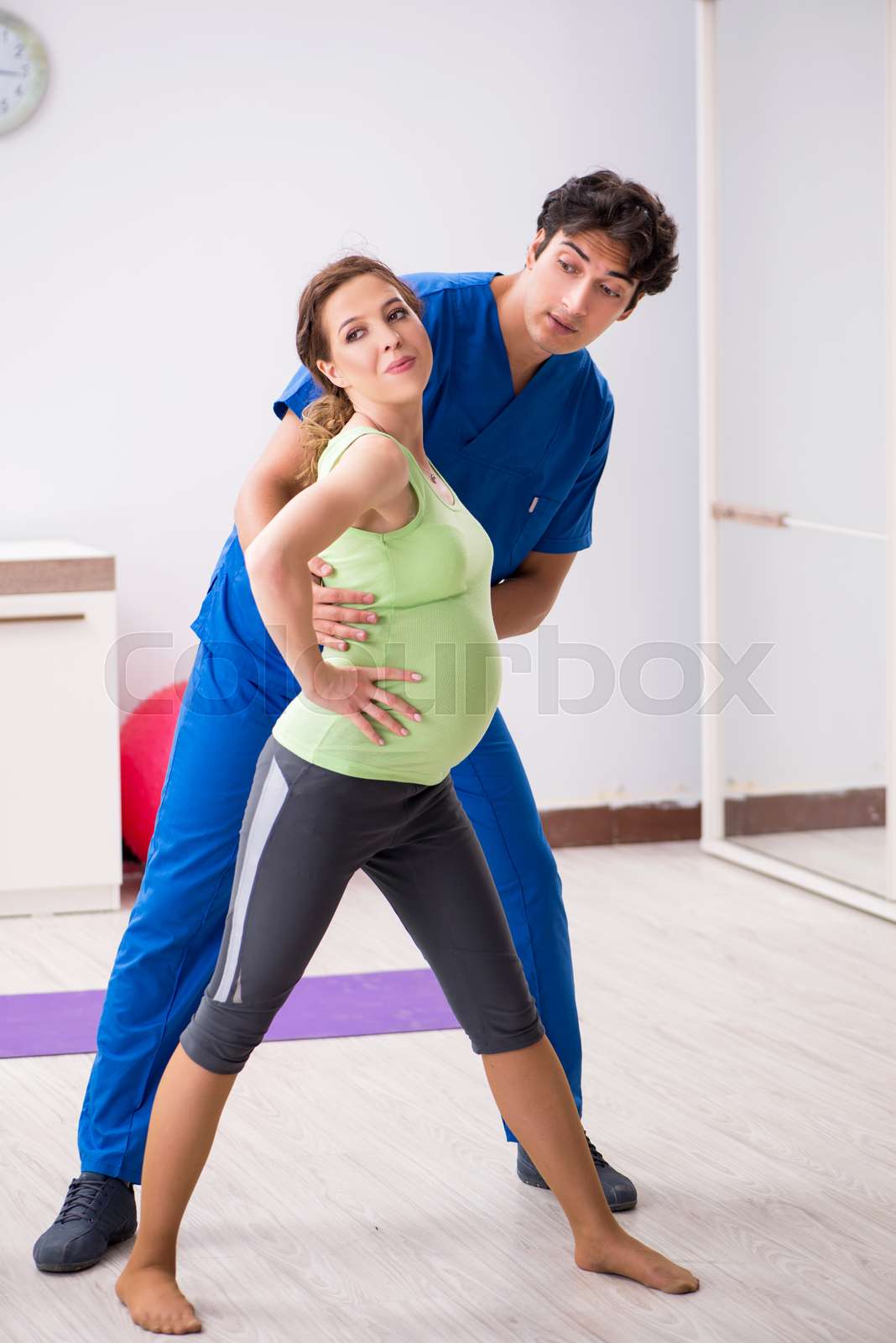 Pregnant woman doing physical exercies with instructor | Stock image ... Pregnant woman doing physical exercies with instructor | Stock image ...