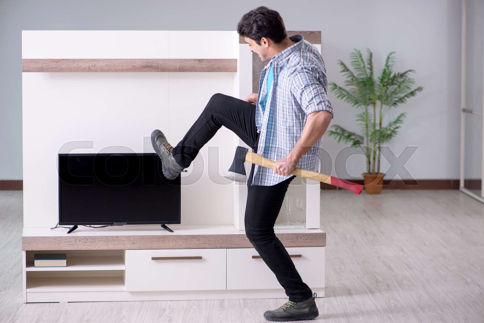 Man trying to fix broken tv | Stock image | Colourbox